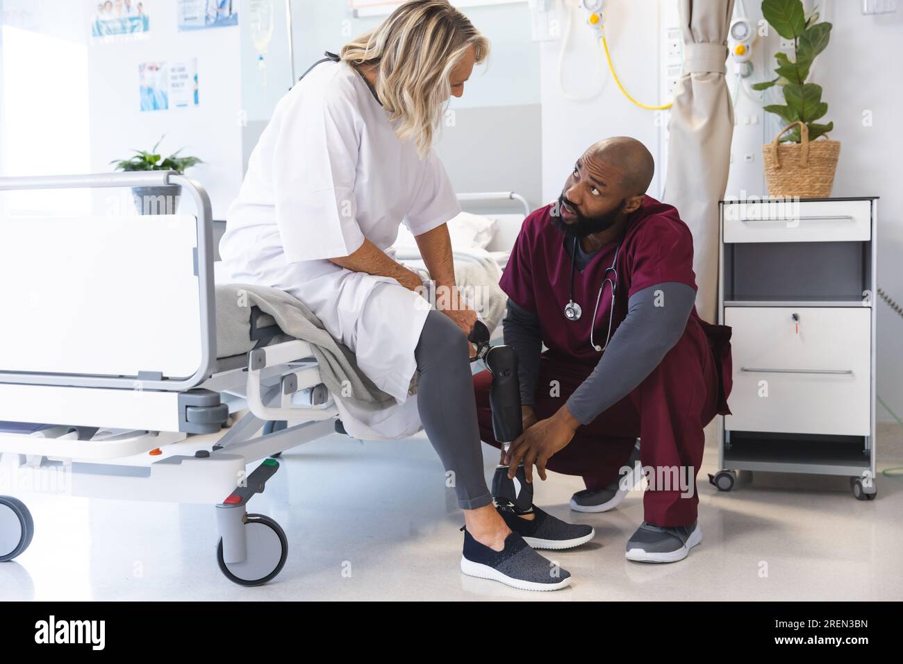 African american male doctor examining senior caucasian female patient ...