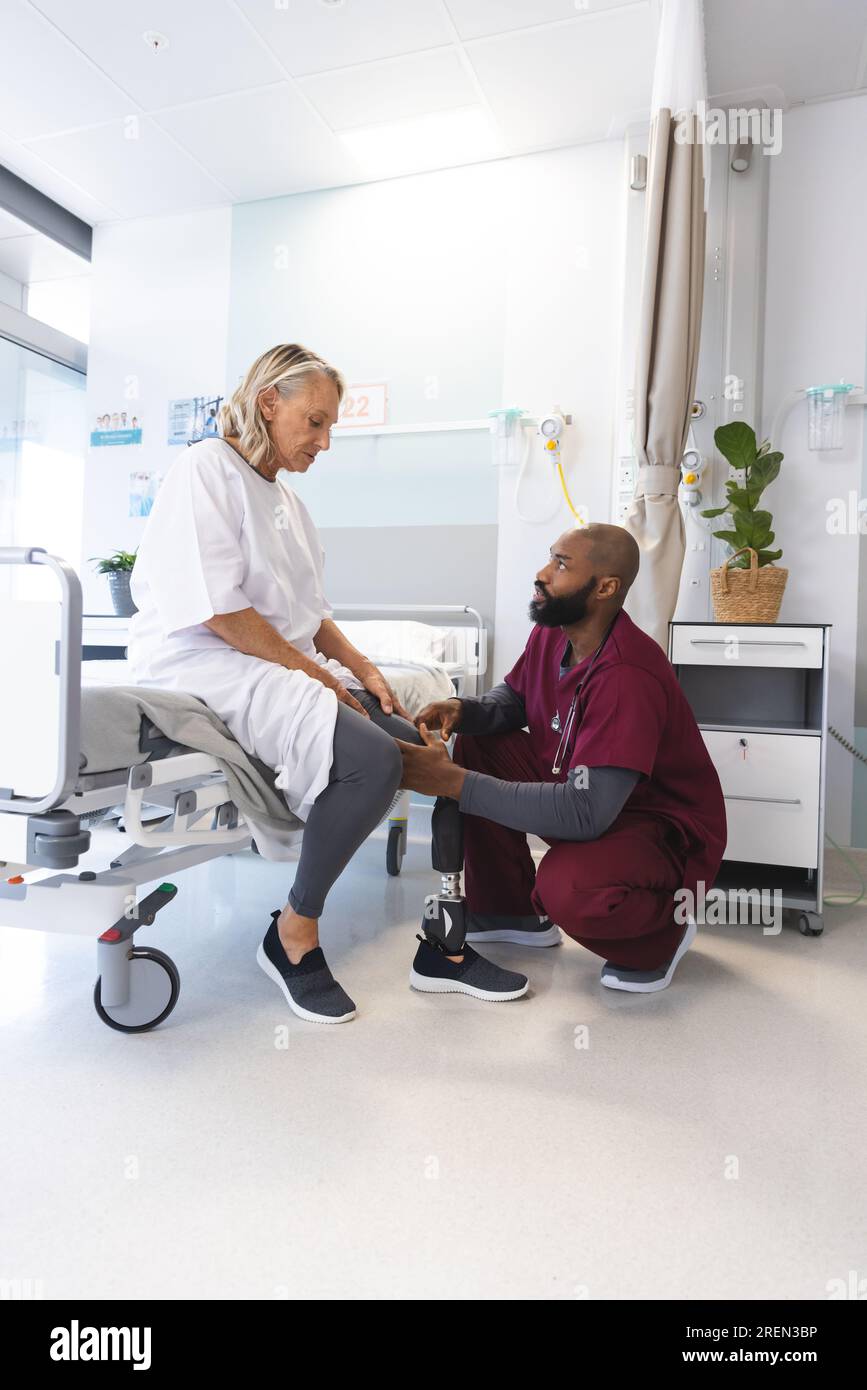 African american male doctor examining senior caucasian female patient ...