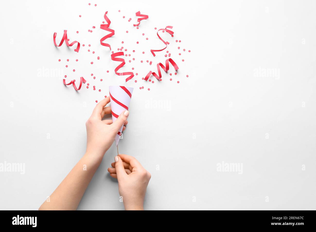 Woman with party popper hi-res stock photography and images - Alamy