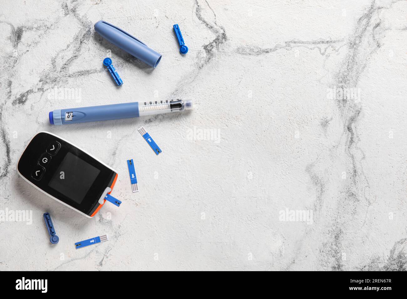 Glucometer with strips and lancet pen on grunge background. Diabetes ...