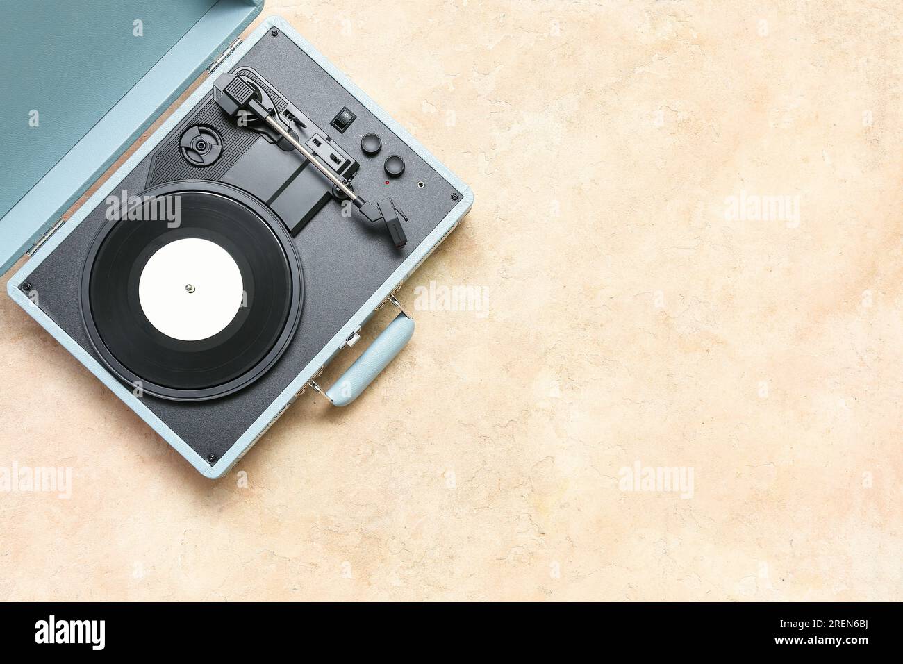 Record player with vinyl disk on beige background Stock Photo - Alamy