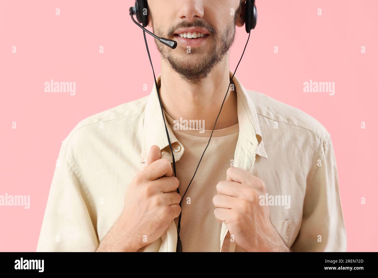 Male technical support agent on pink background Stock Photo - Alamy