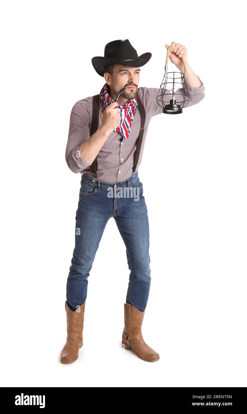 Handsome cowboy with lantern and smoking pipe on white background Stock ...
