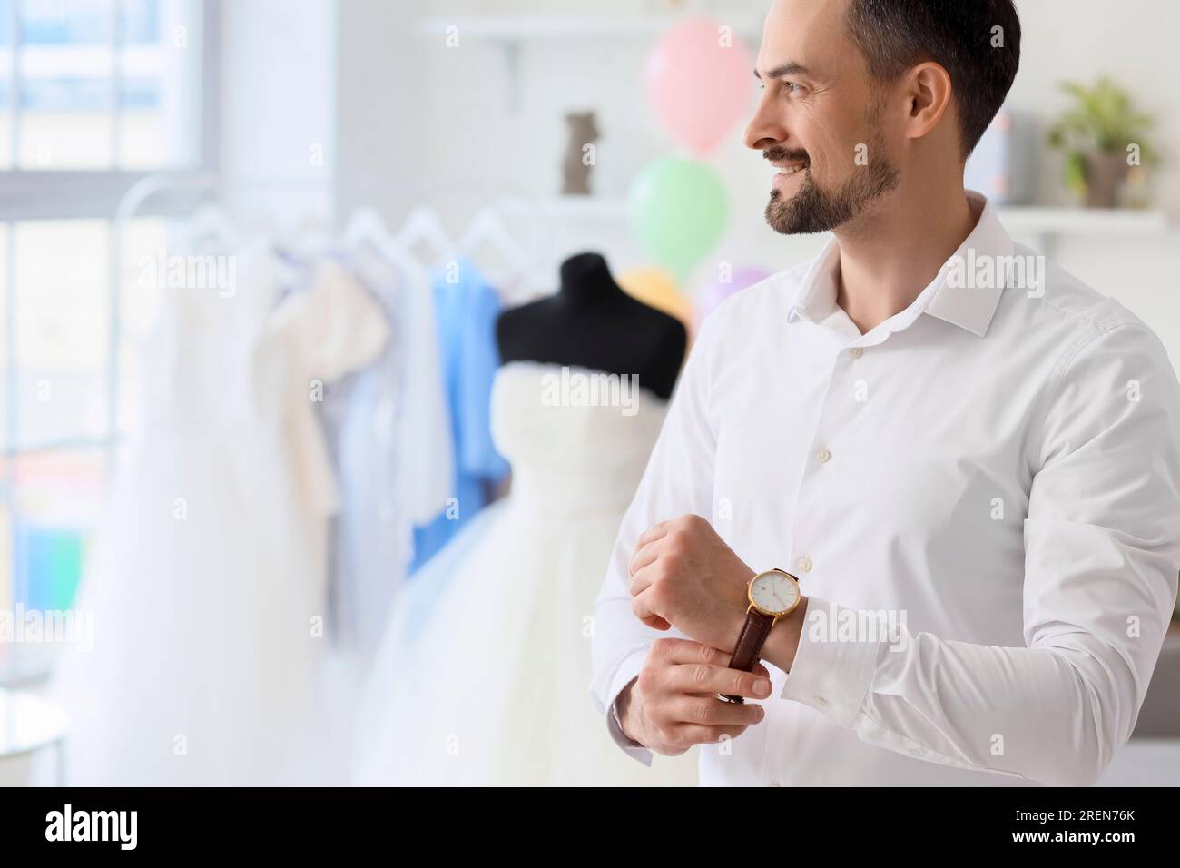 Male wedding planner working in office Stock Photo - Alamy