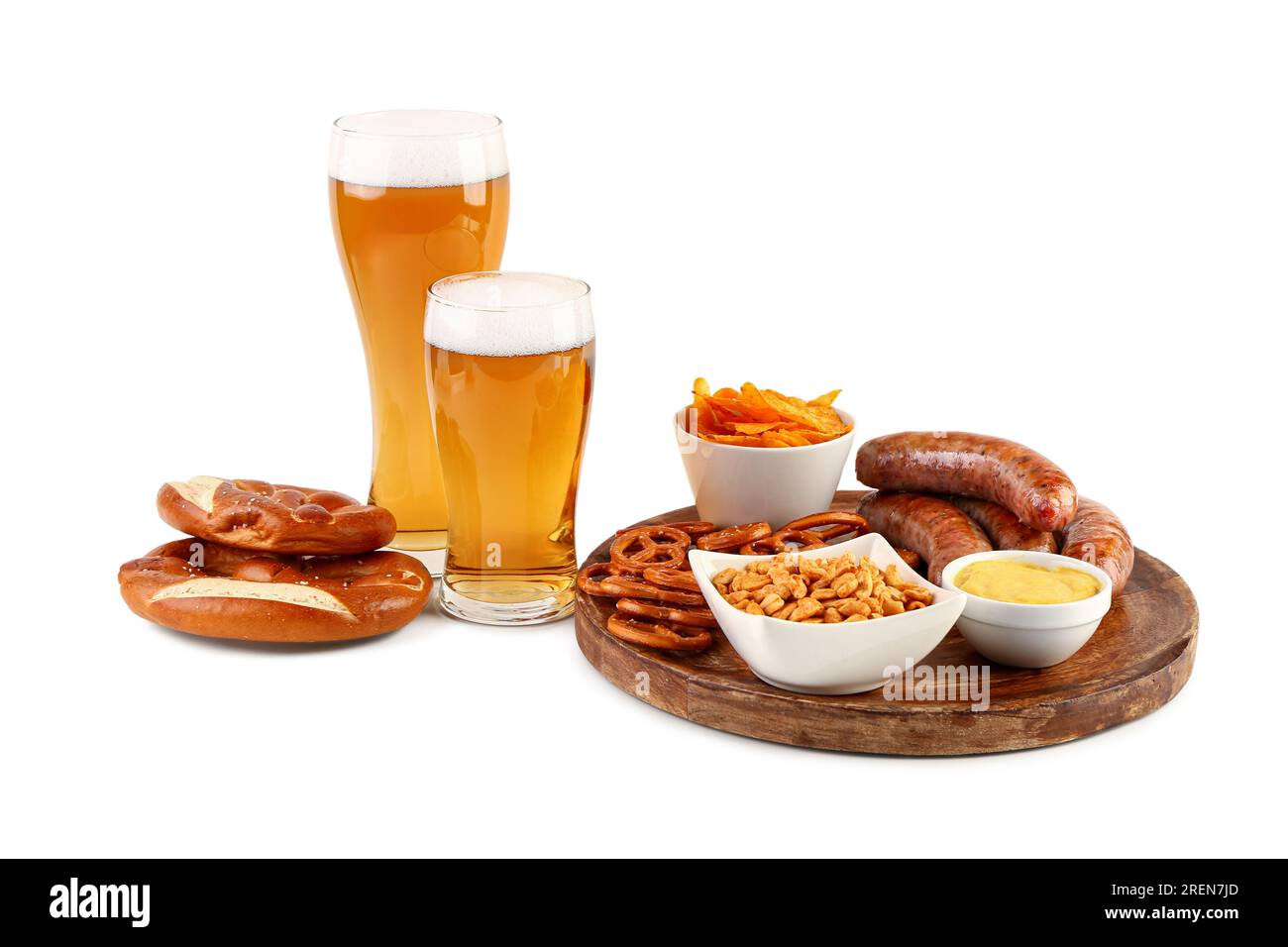 Glasses of cold beer and plate with different snacks on white ...