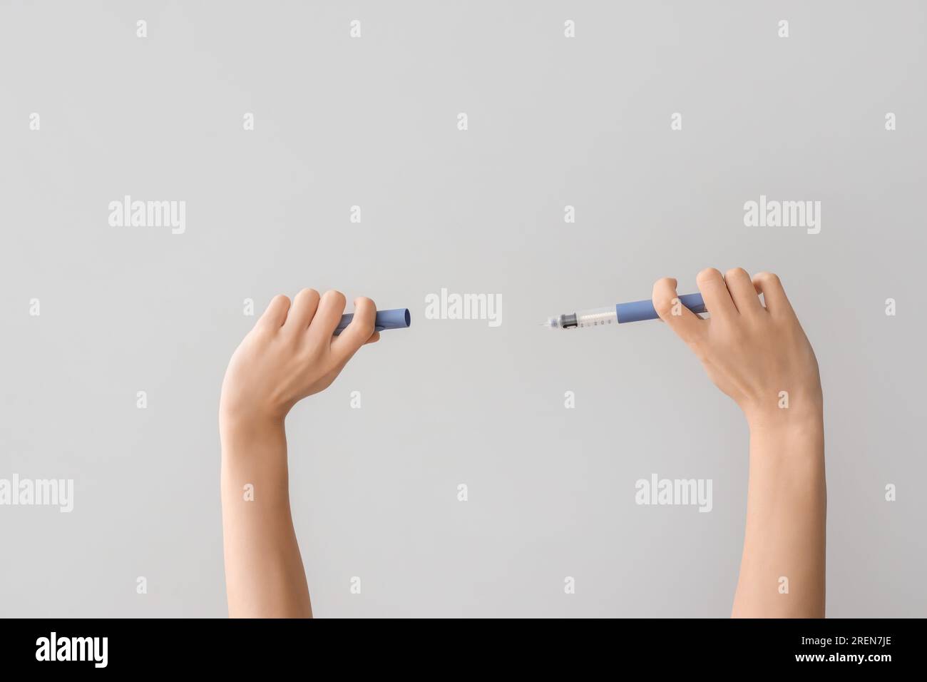 Female hands with insulin syringe on grey background Stock Photo - Alamy