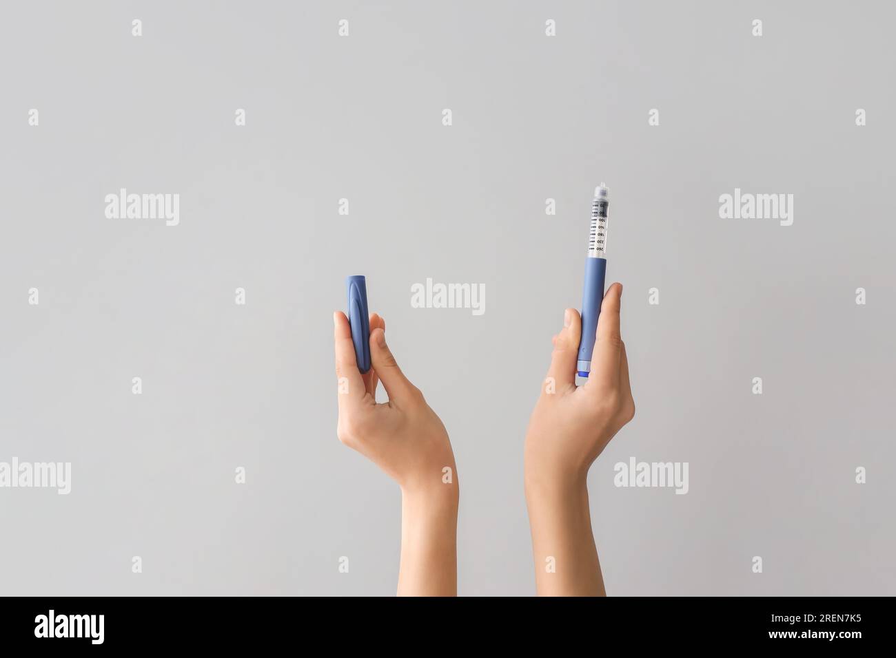 Female hands with insulin syringe on grey background Stock Photo - Alamy