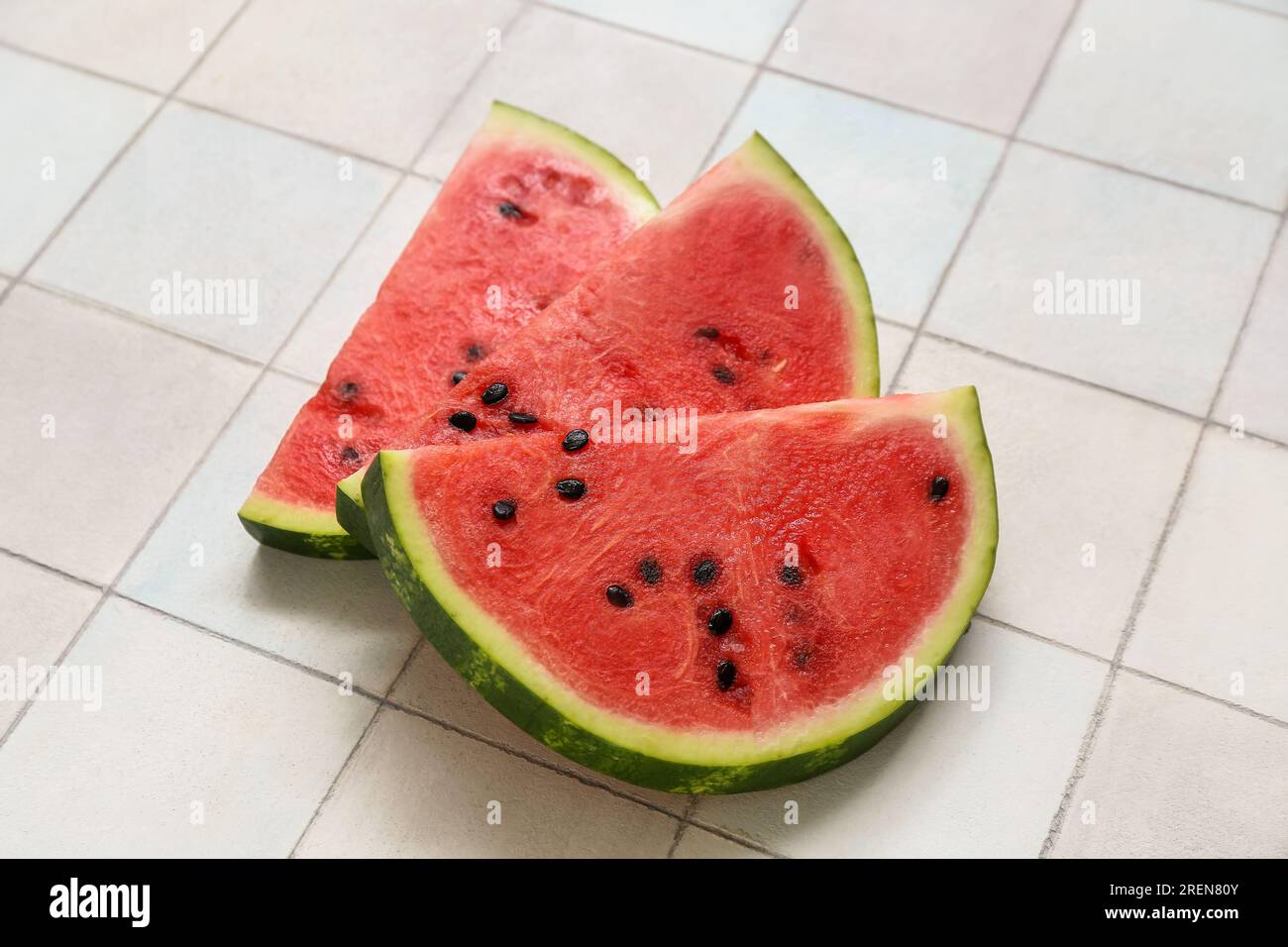 Pieces of fresh watermelon on white tile background Stock Photo - Alamy