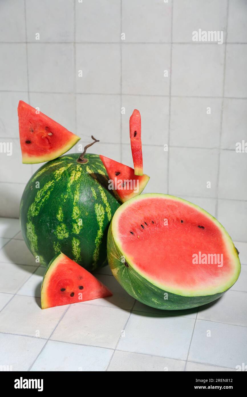 Fresh watermelons on white tile background Stock Photo - Alamy