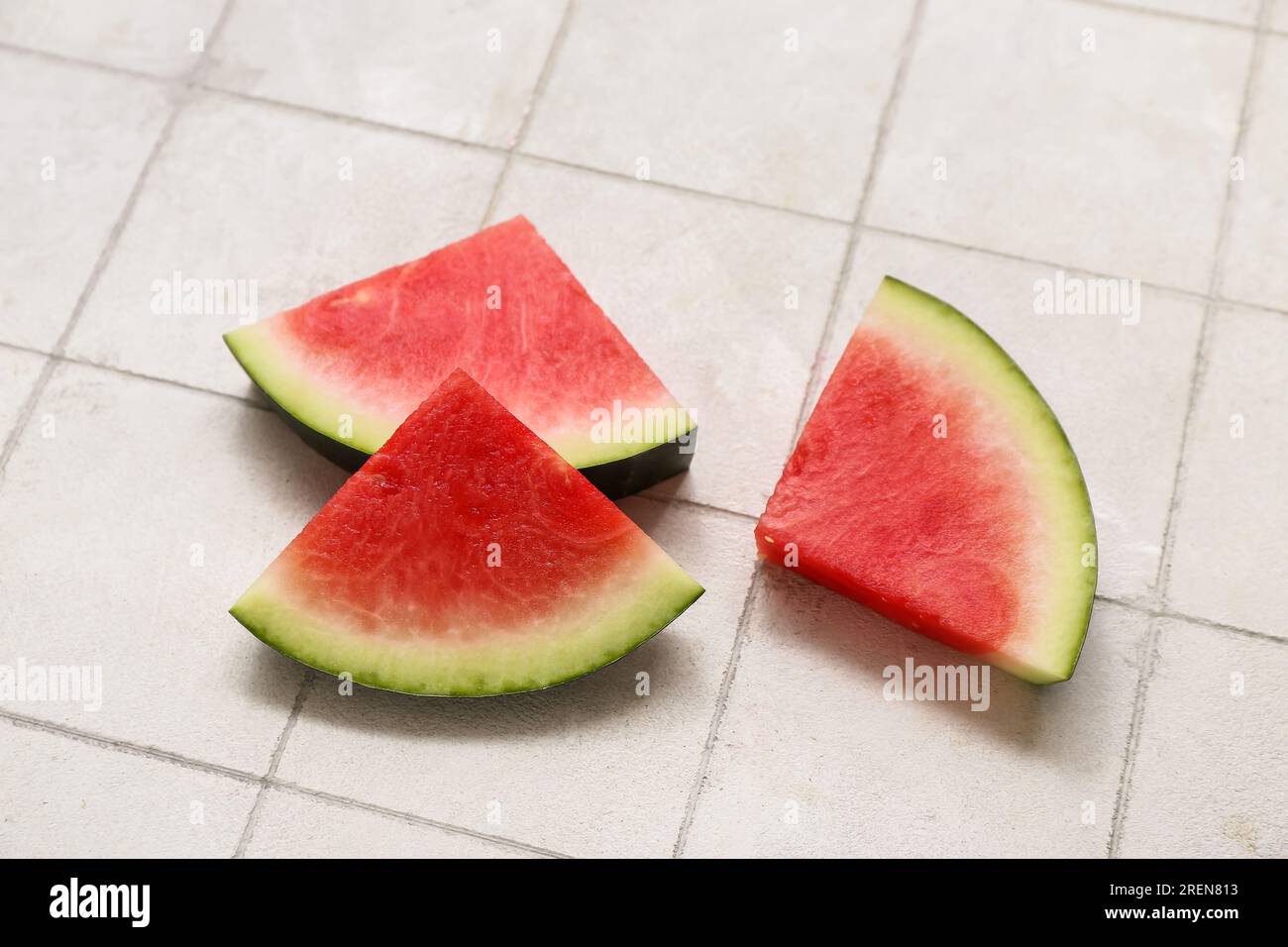 Pieces of fresh watermelon on white tile background Stock Photo - Alamy