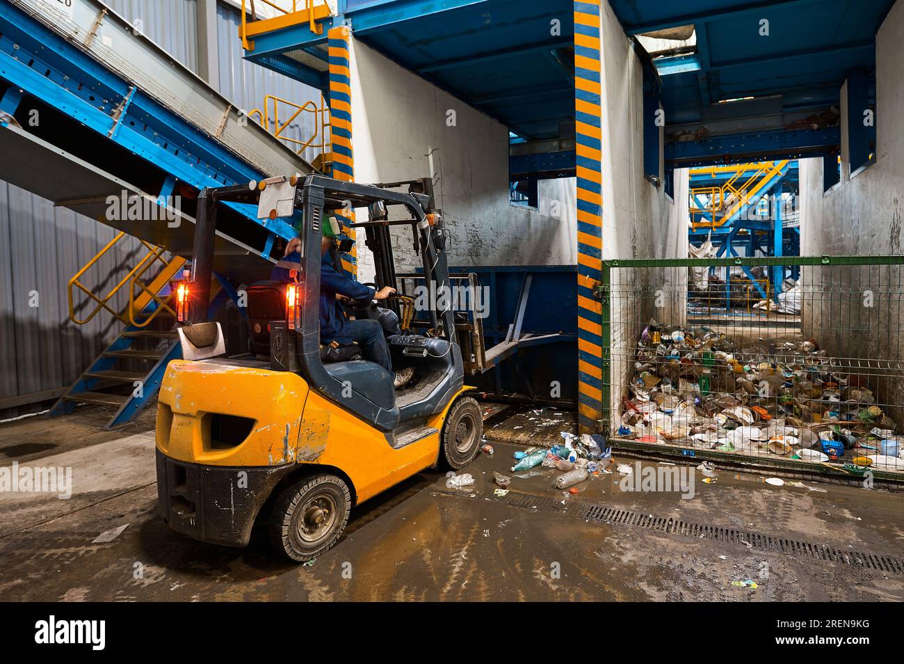 The bulldozer loader compacts the sorted waste in the storage bin ...