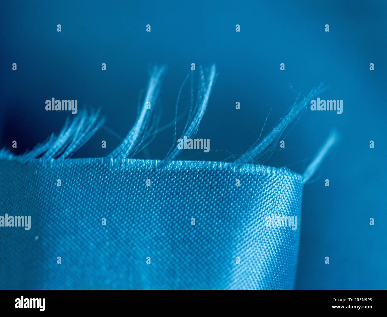 Blue Satin fabric, silky threads on rough edge fraying Stock Photo - Alamy