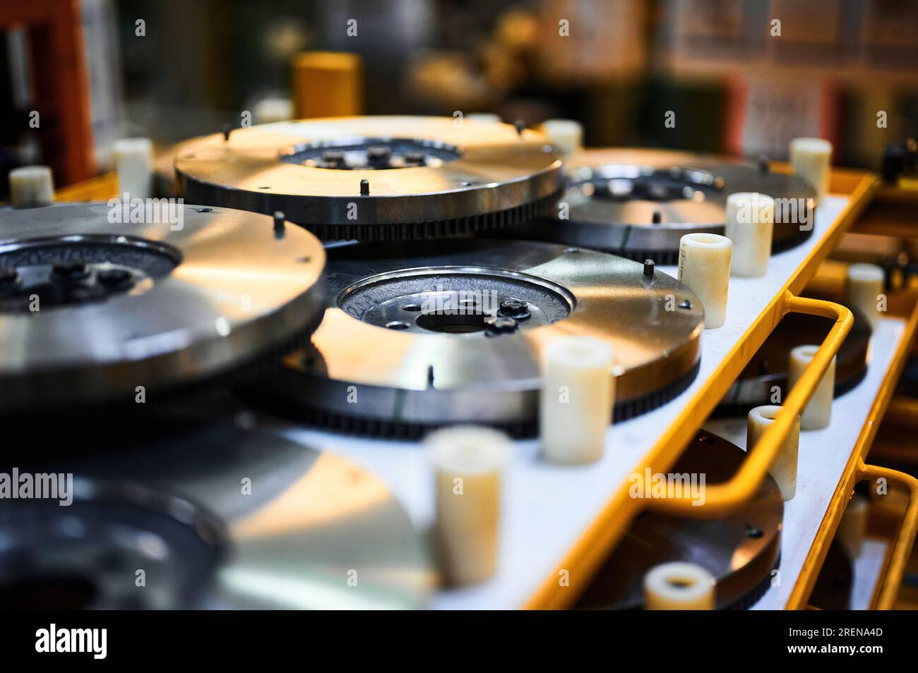 Car engine flywheels on shelf at auto production factory Stock Photo ...