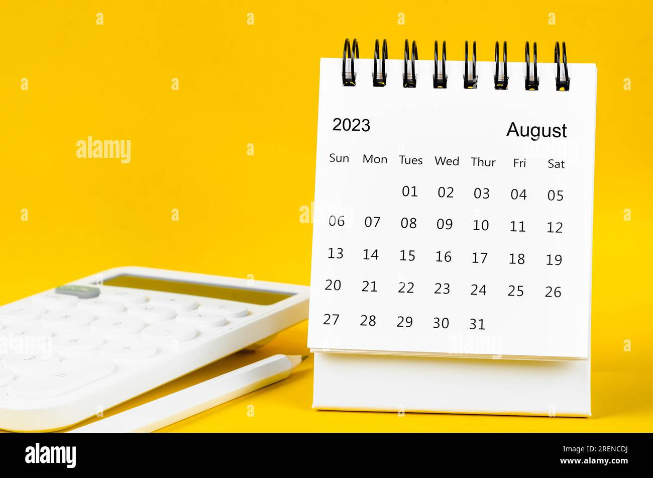 August 2023 Monthly desk calendar for 2023 year and calculator with pen ...