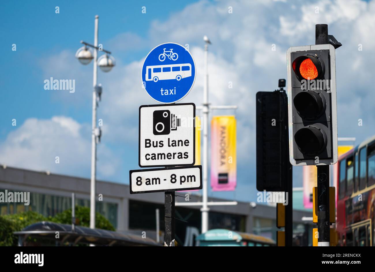Signs and traffic lights at road junction, showing bus lane, cycle lane, taxi lane, warning of ...