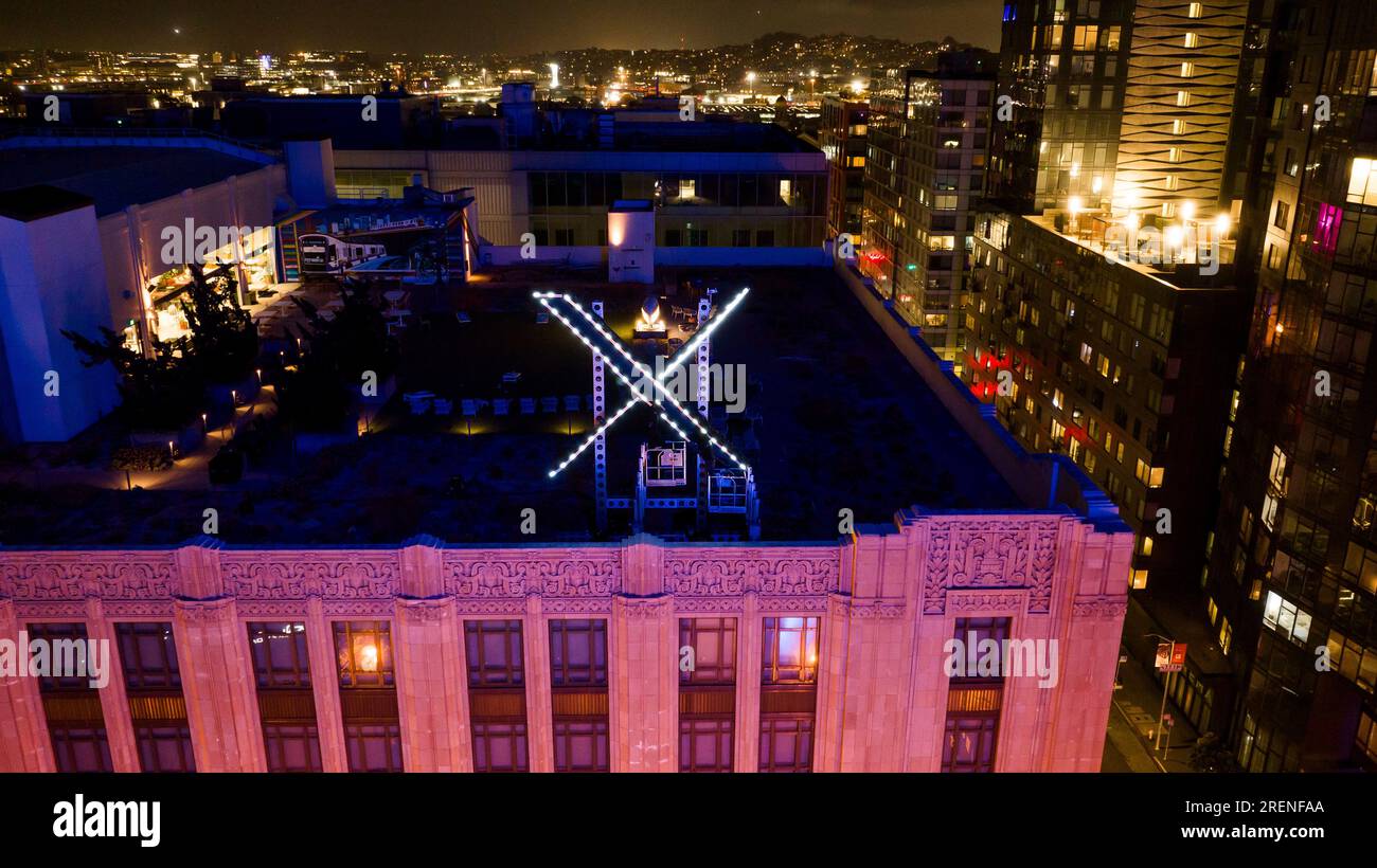 Workers install lighting on an "X" sign atop the company headquarters ...