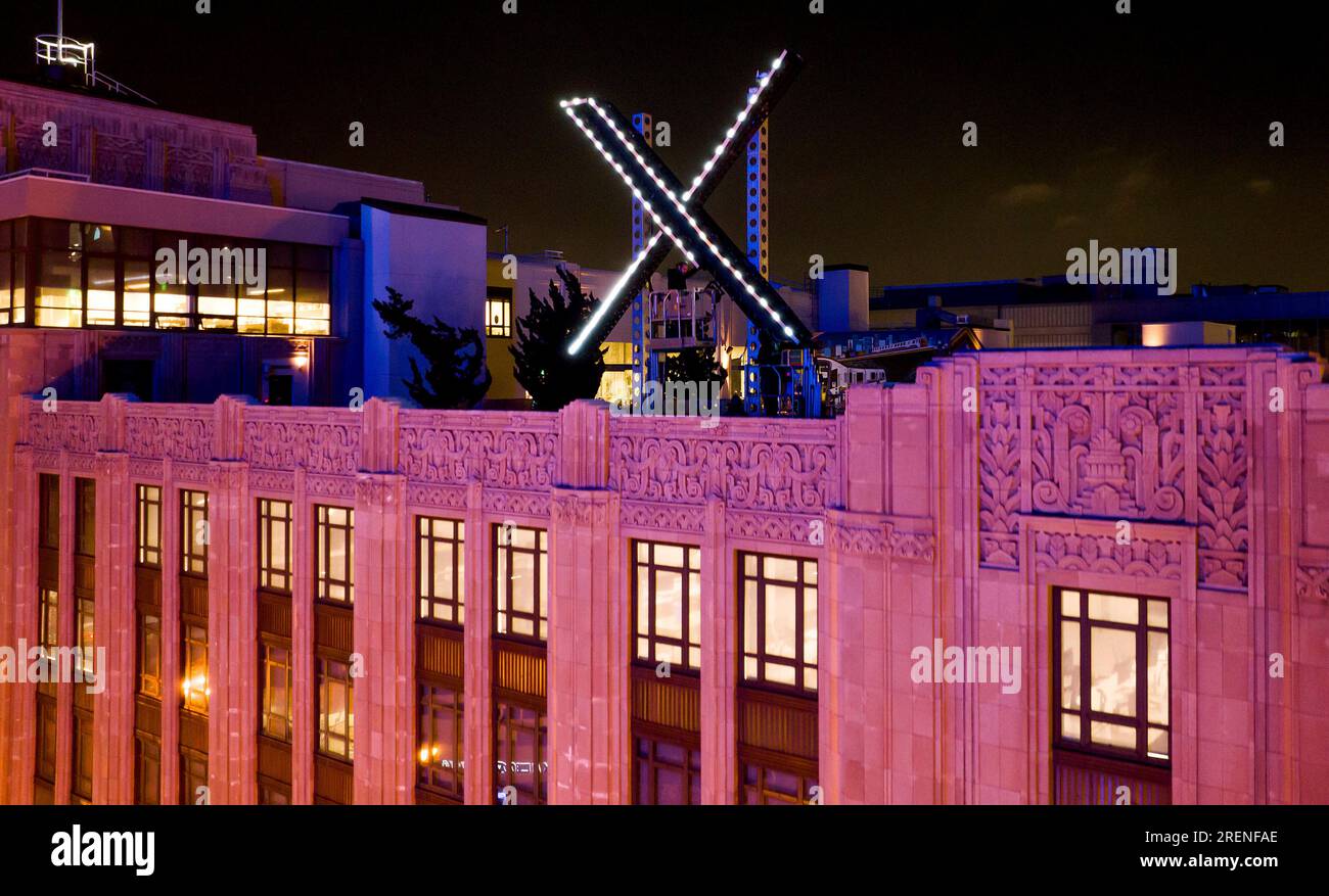 Workers install lighting on an "X" sign atop the company headquarters ...