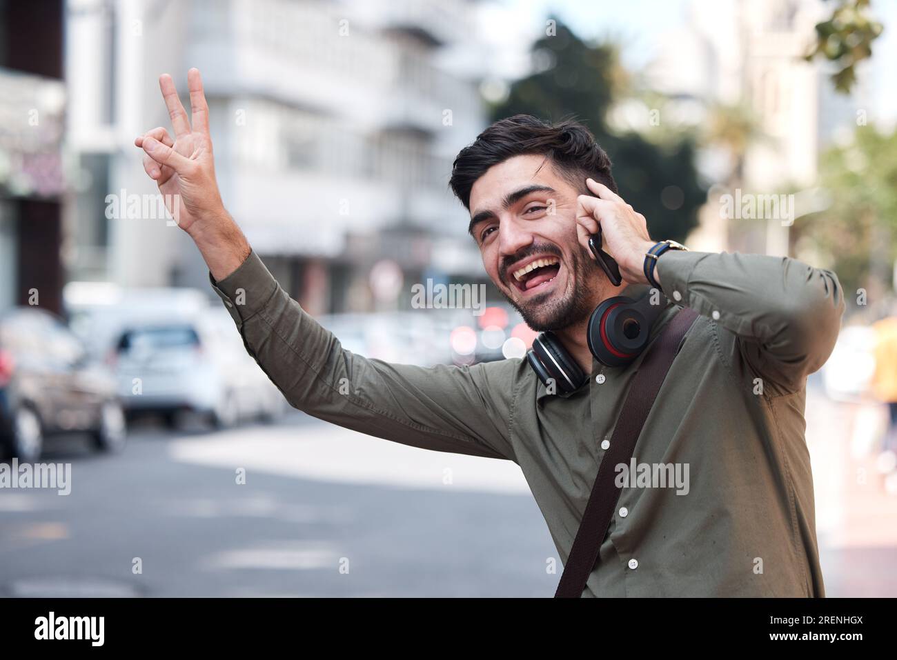 Man, phone call and wave for taxi, city and smile for peace sign ...