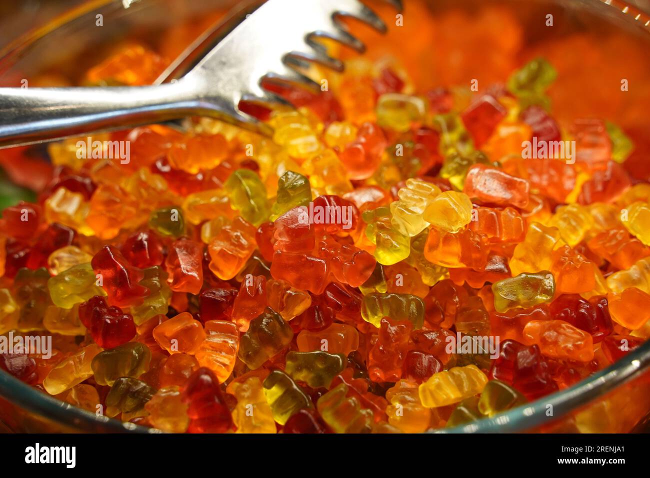Gummy orange-yellow candies on the counter in the candy shop in Prague ...
