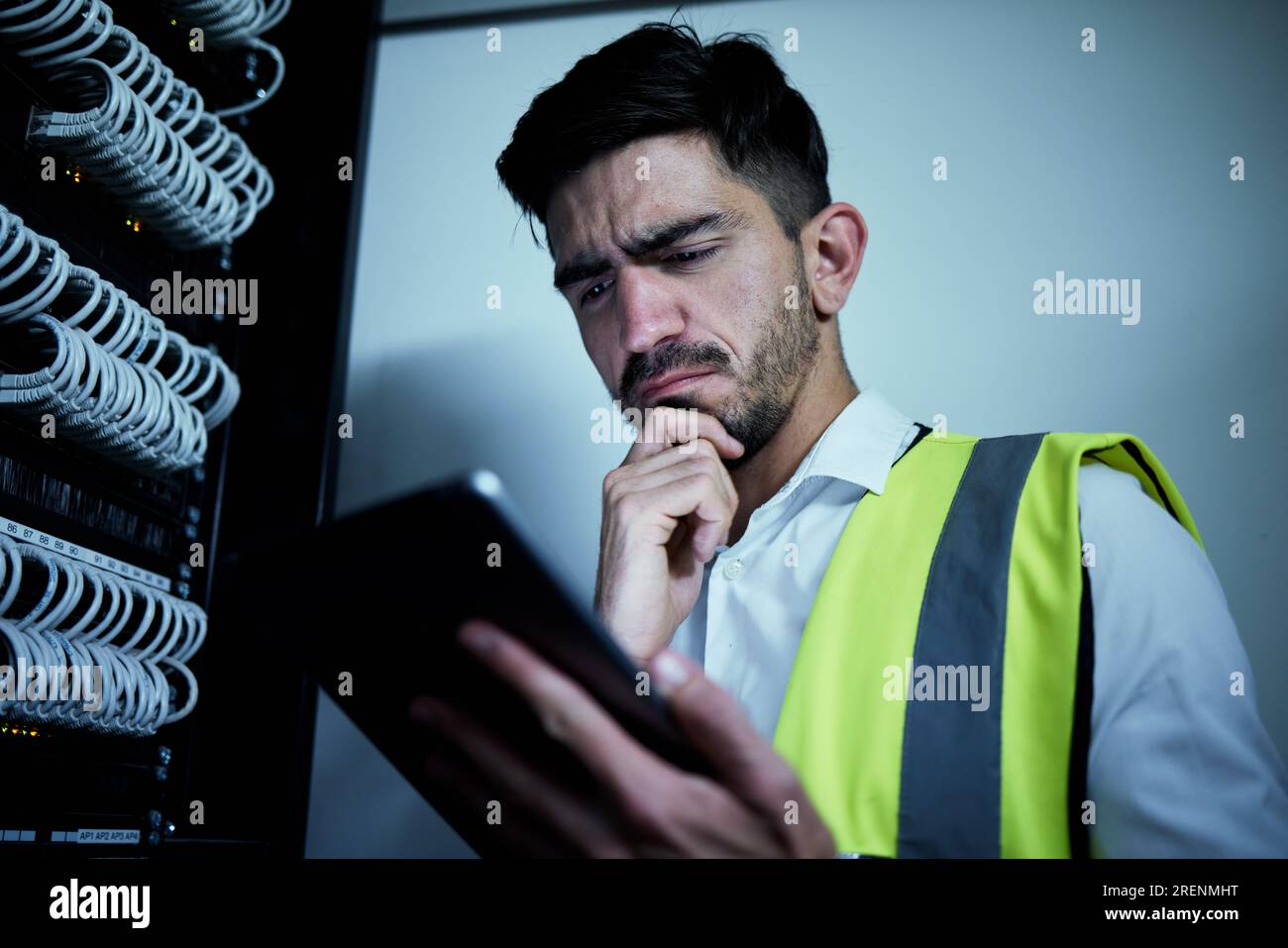 Engineer man, thinking and tablet in server room for information ...