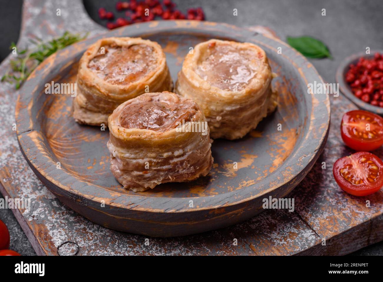 Delicious baked meat roll wrapped in bacon with salt, spices and herbs ...