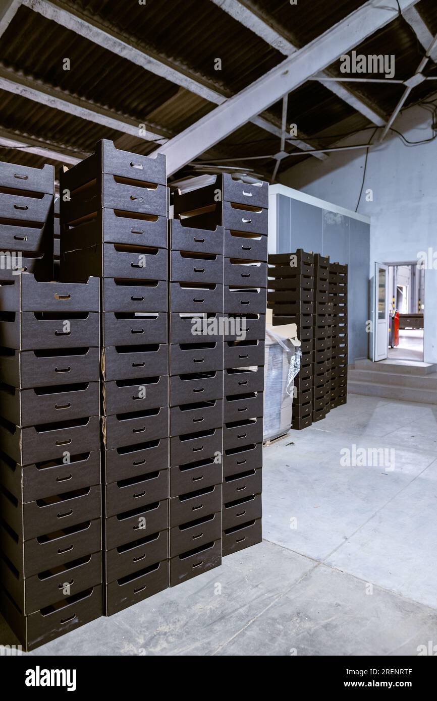 Assembled black cardboard boxes in warehouse. Fruit trays. Packaging of ...