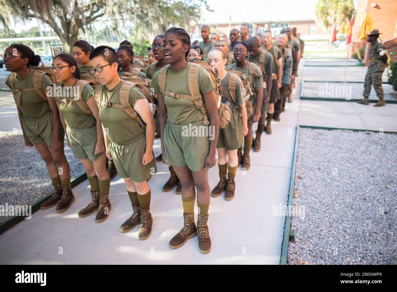 A detail of female U.S. Marine Corps recruits stand in platoon order ...