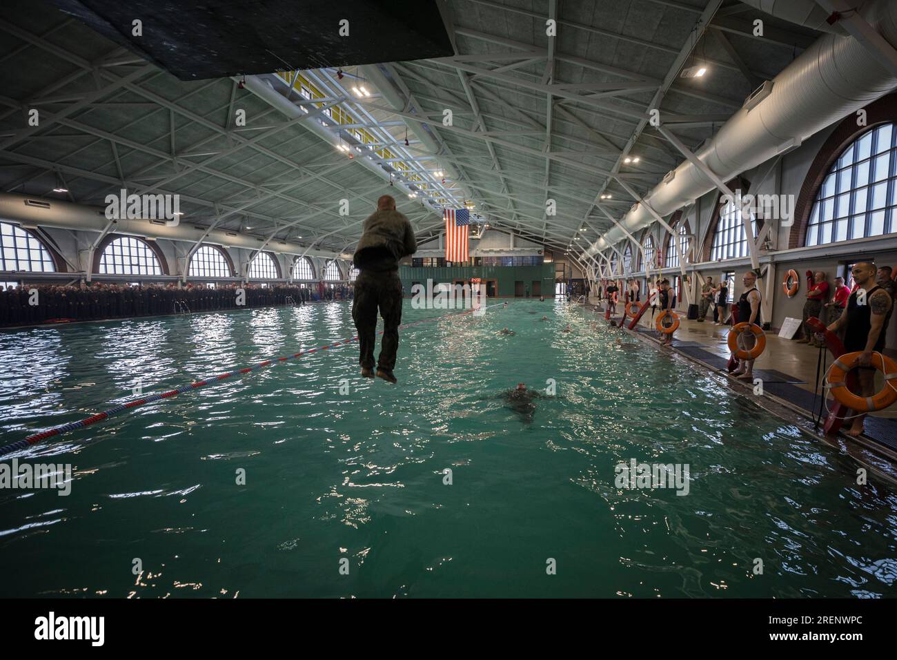 A U.S. Marine Corps recruit jumps into the water during swim training ...