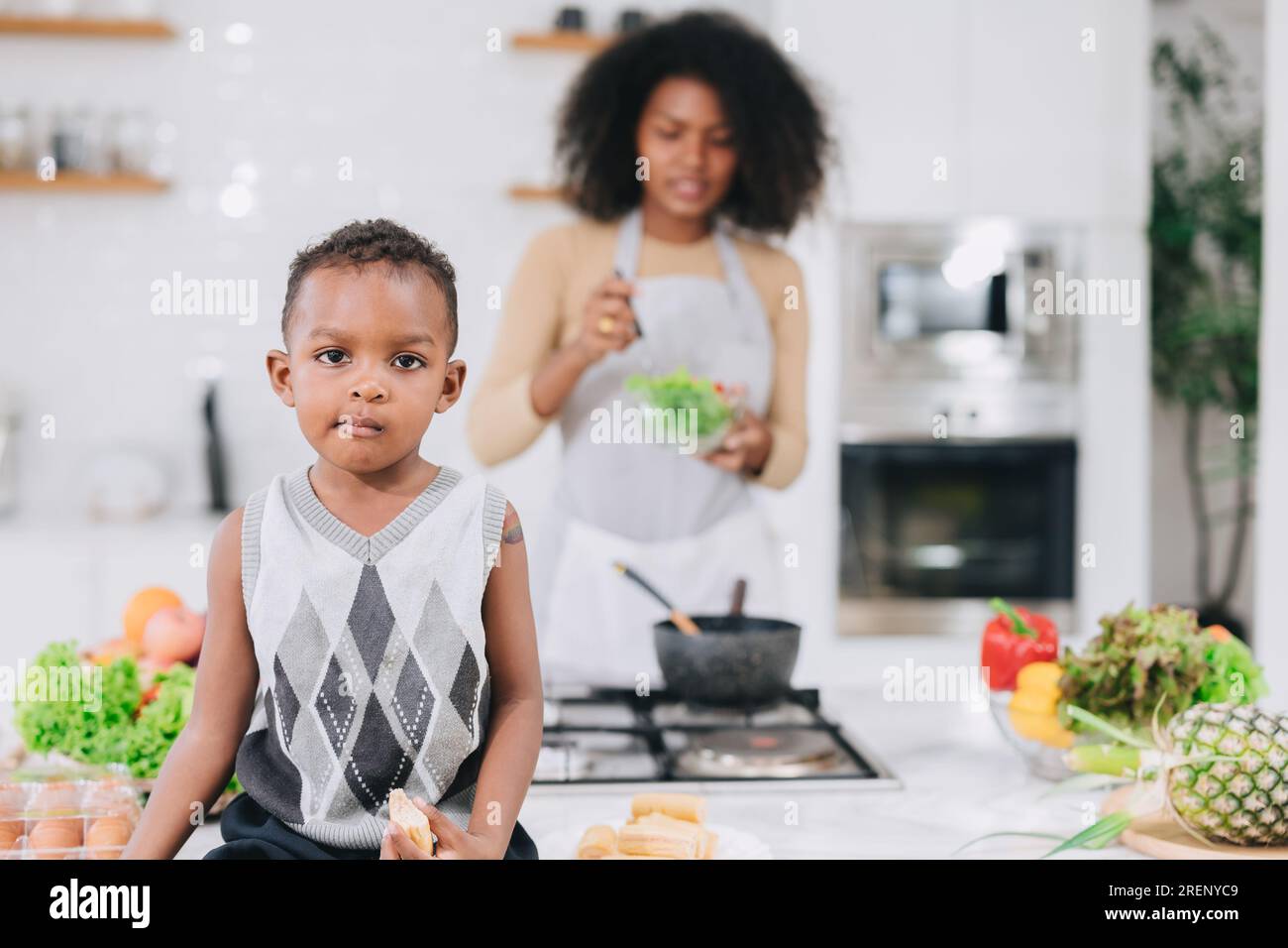happy african black young mother with her boy lovely cute cooking ...