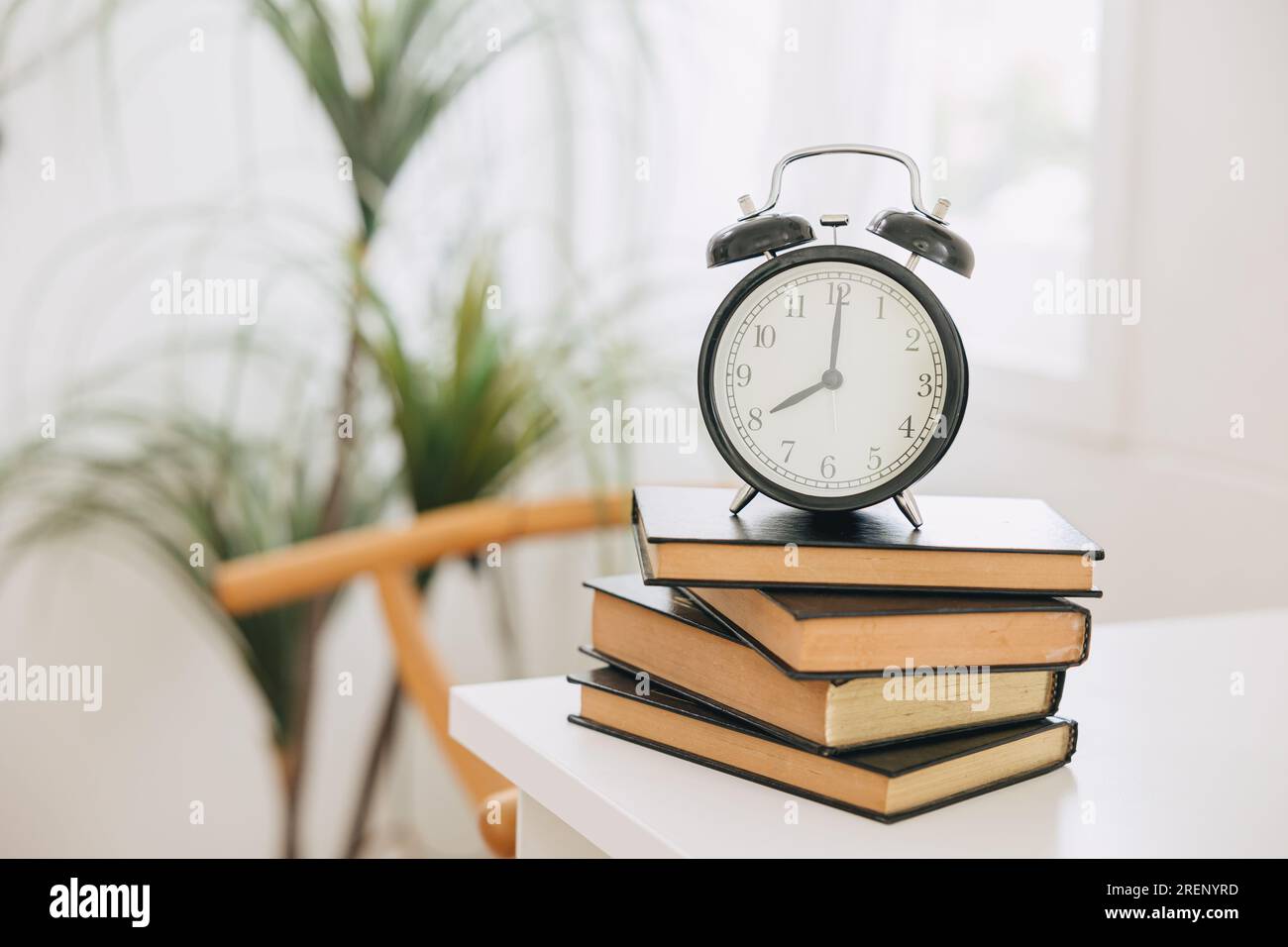 old bell clock on stack books, times for learning reading education ...