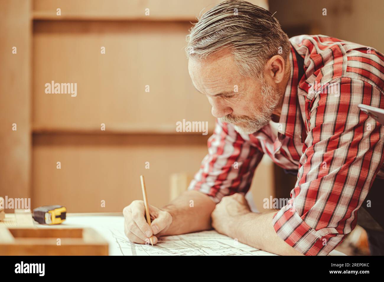 Senior professional engineer architect male working design drawing ...