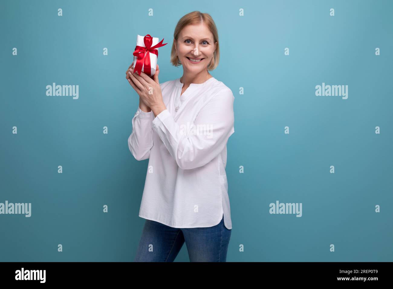 happy 50s woman received a gift on studio background Stock Photo - Alamy