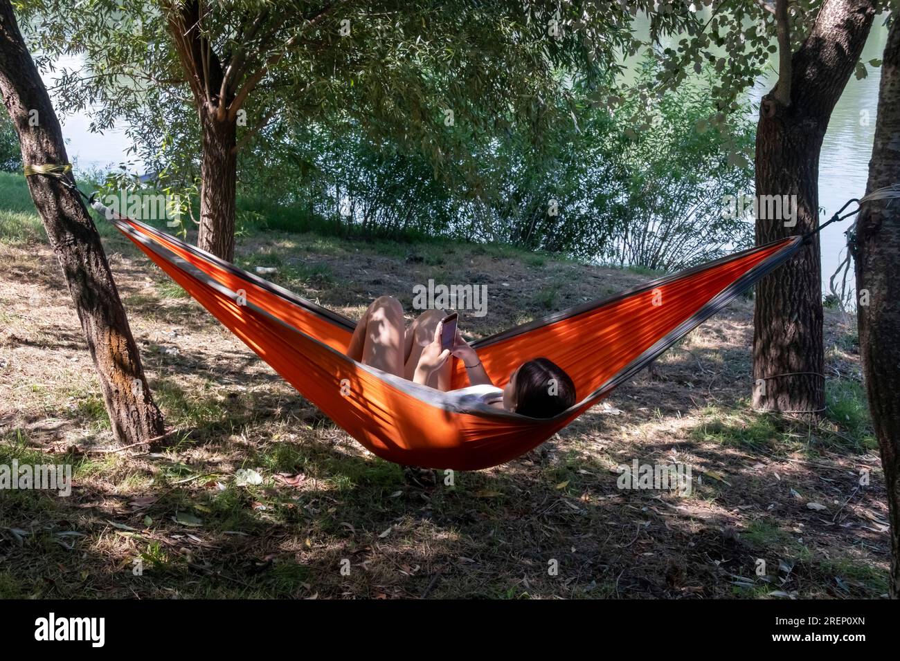 Girl in hammock by the river Stock Photo - Alamy