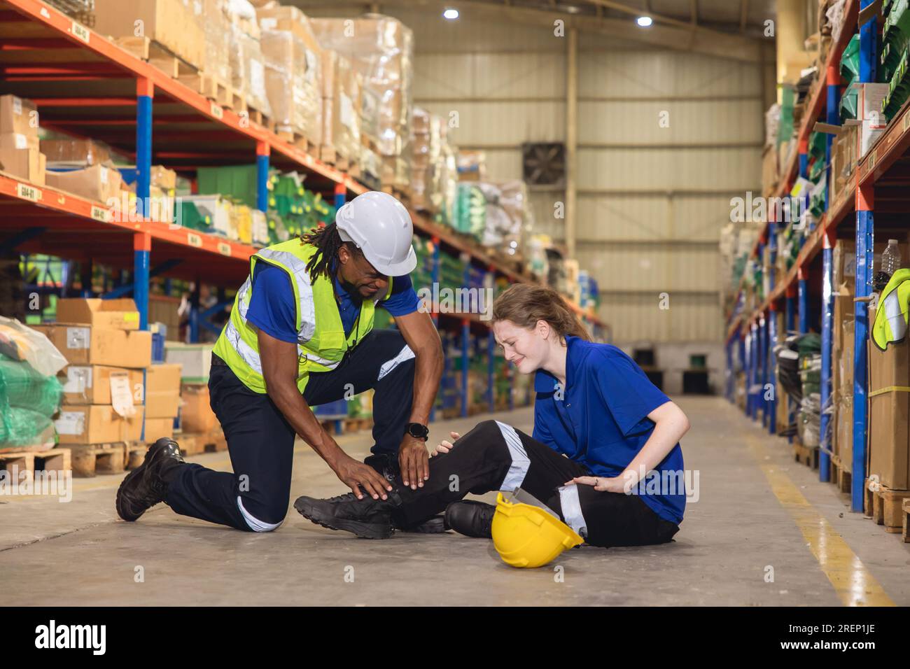 young woman warehouse worker accident leg injury slip and fall ankle ...