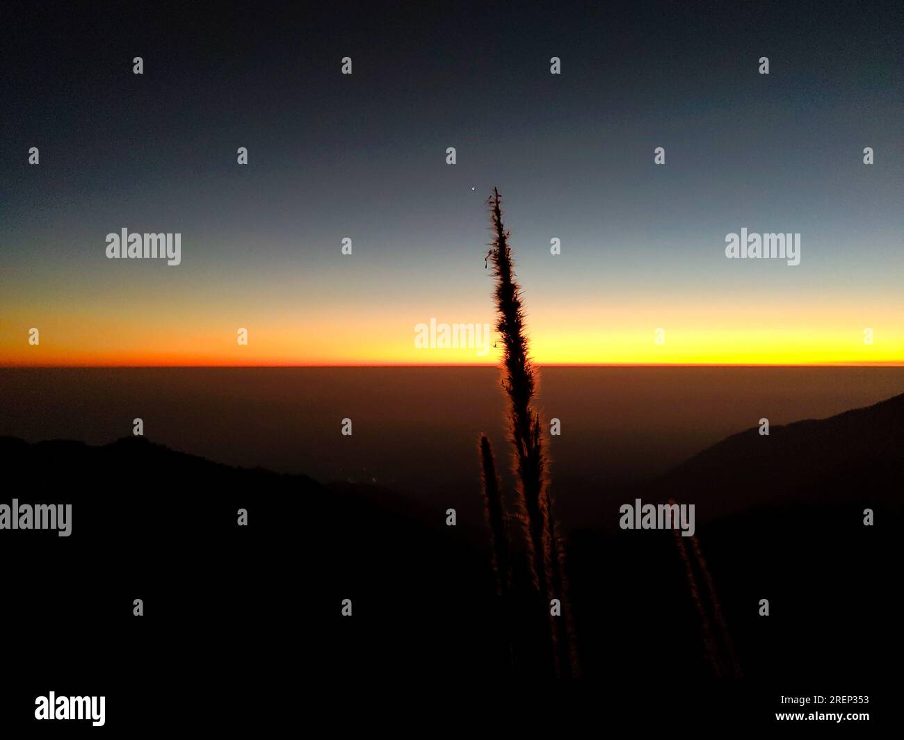 Exotic 180-degree shot of orange winter line with mountain silhouettes ...