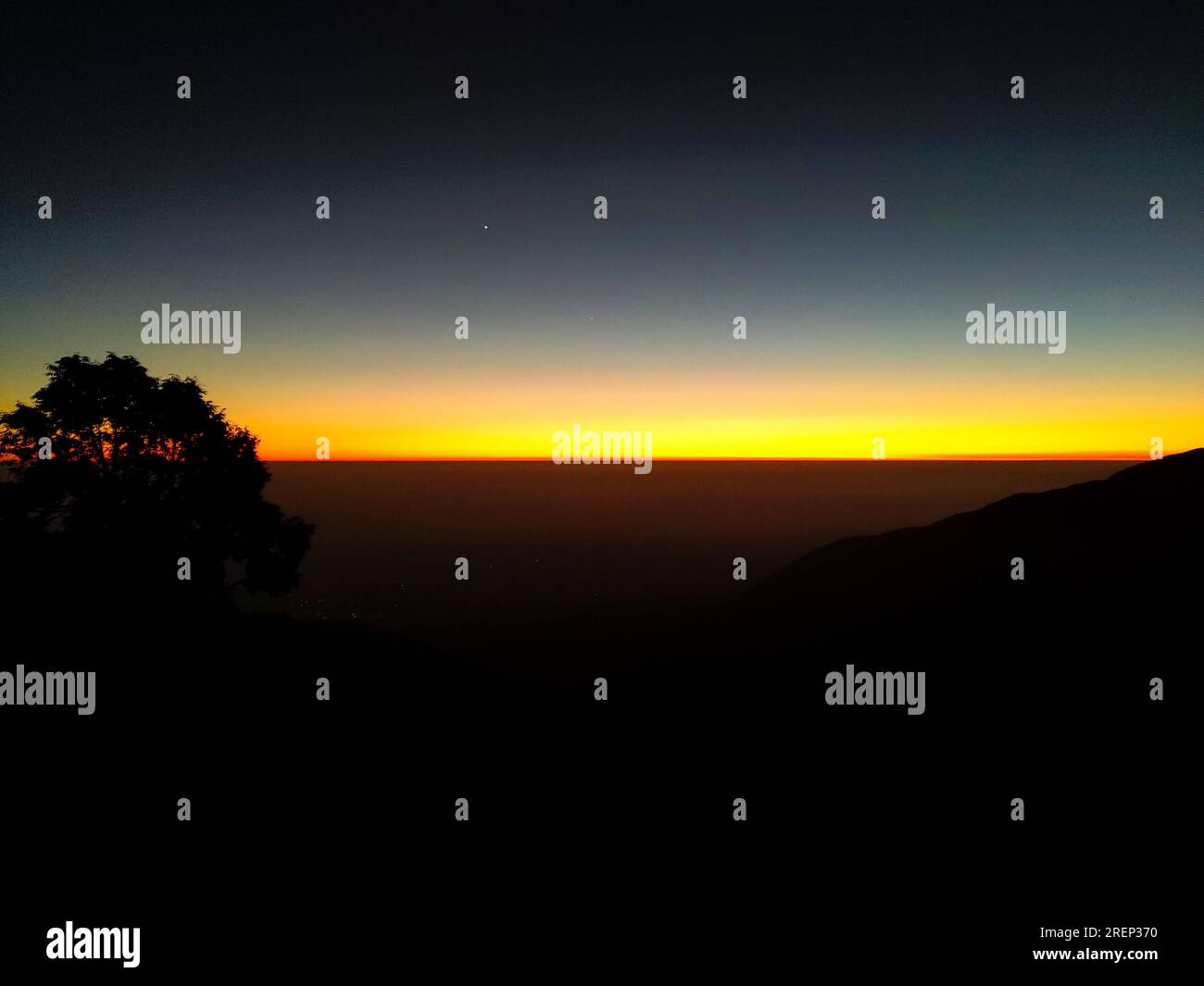 Exotic 180-degree shot of orange winter line with mountain silhouettes ...