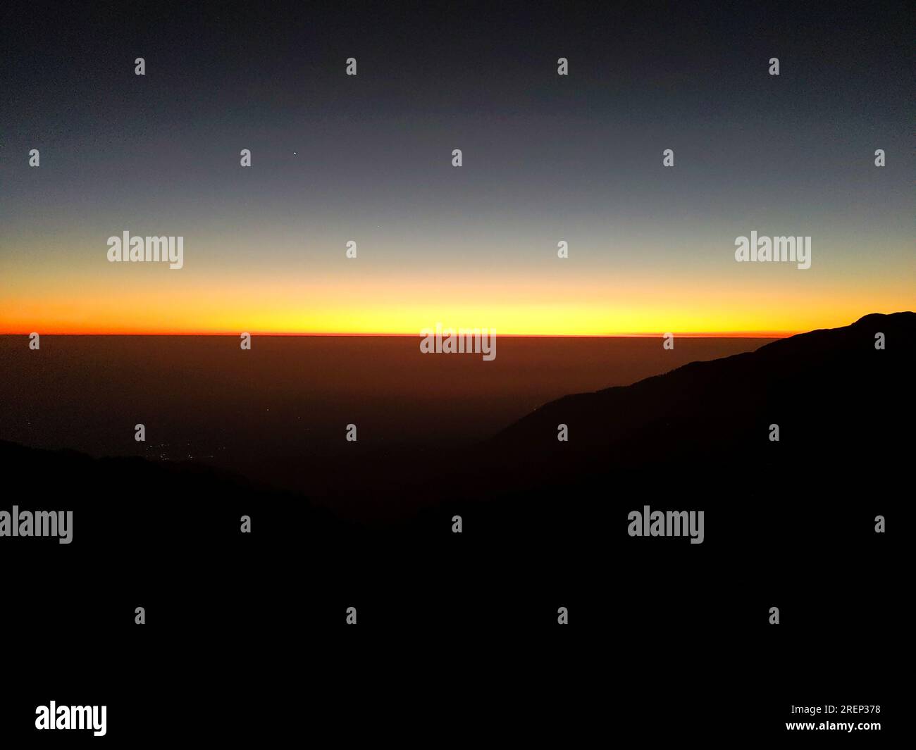 Exotic 180-degree shot of orange winter line with mountain silhouettes ...