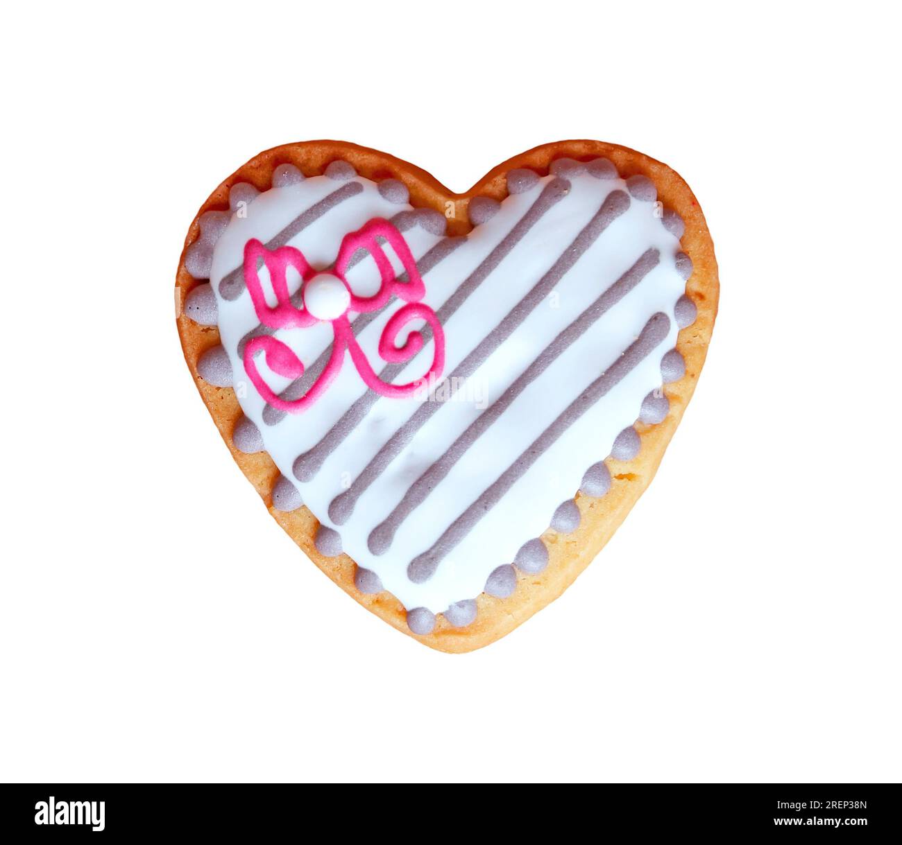 Striped and ribbon patterned royal icing heart shaped cookie on white ...