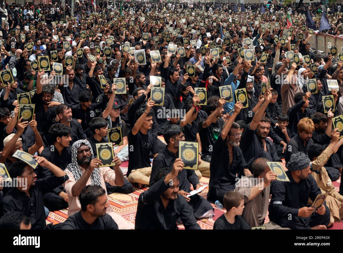 Shiite Muslims hold copies of the Islamic holy book 'Quran' . during a ...