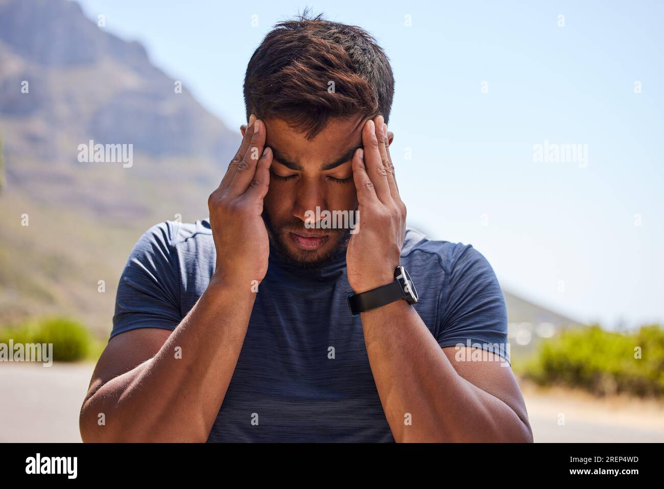 Stress, runner or man with headache in on road after workout, exercise ...