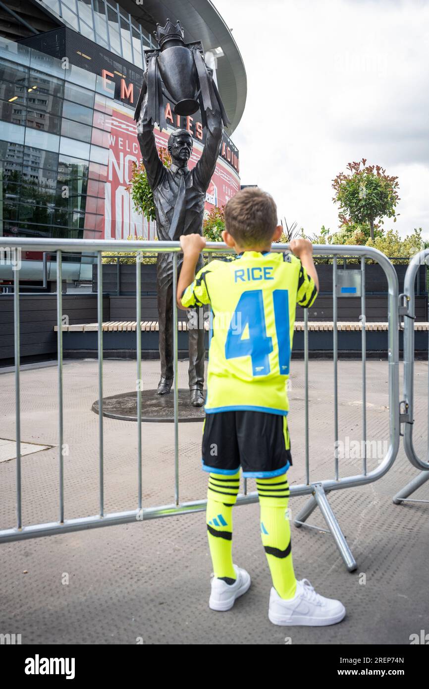 London, UK. 29 July 2023. A young fan views the statue of Arsenal ...