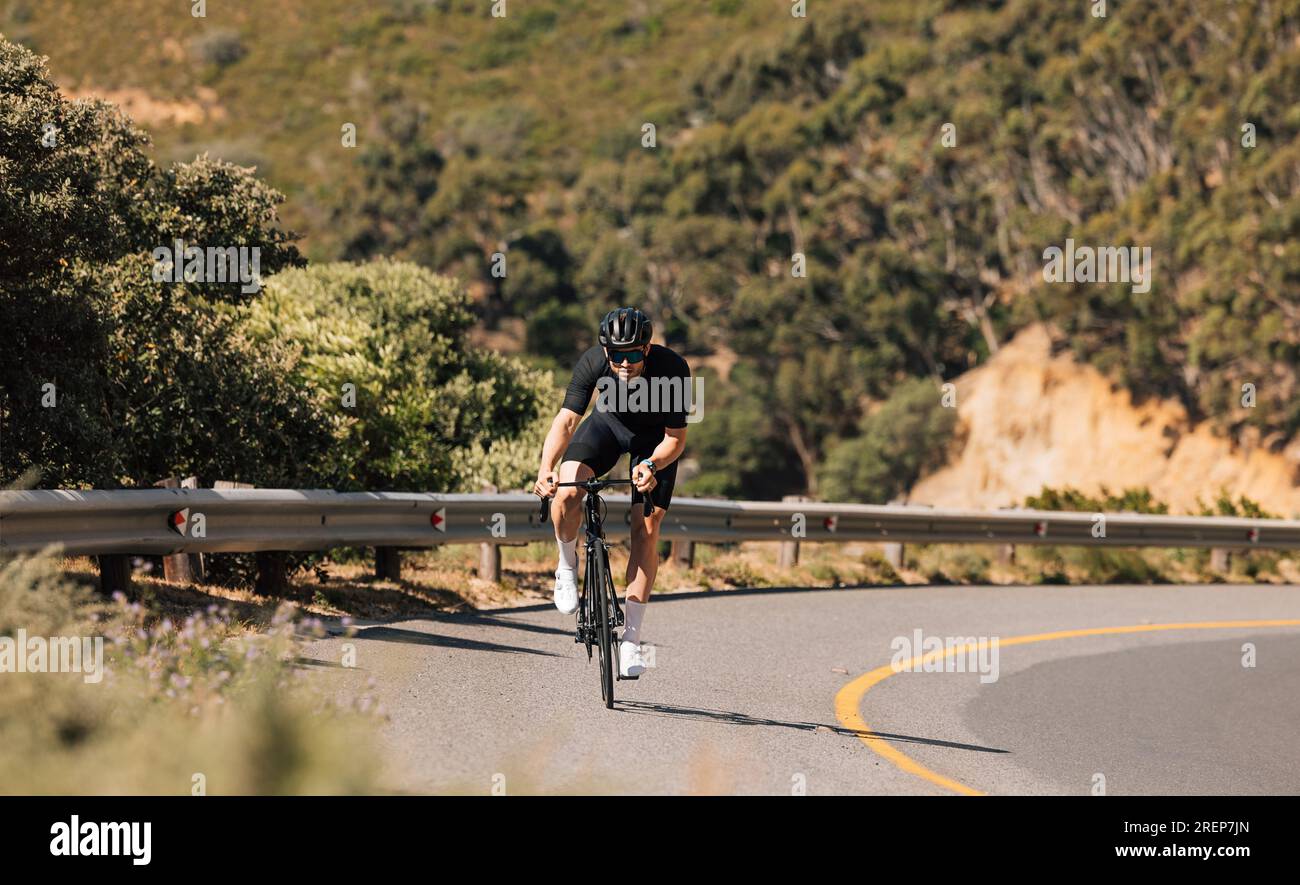 Fit cyclist doing an intense ride on an empty mountain road Stock Photo ...
