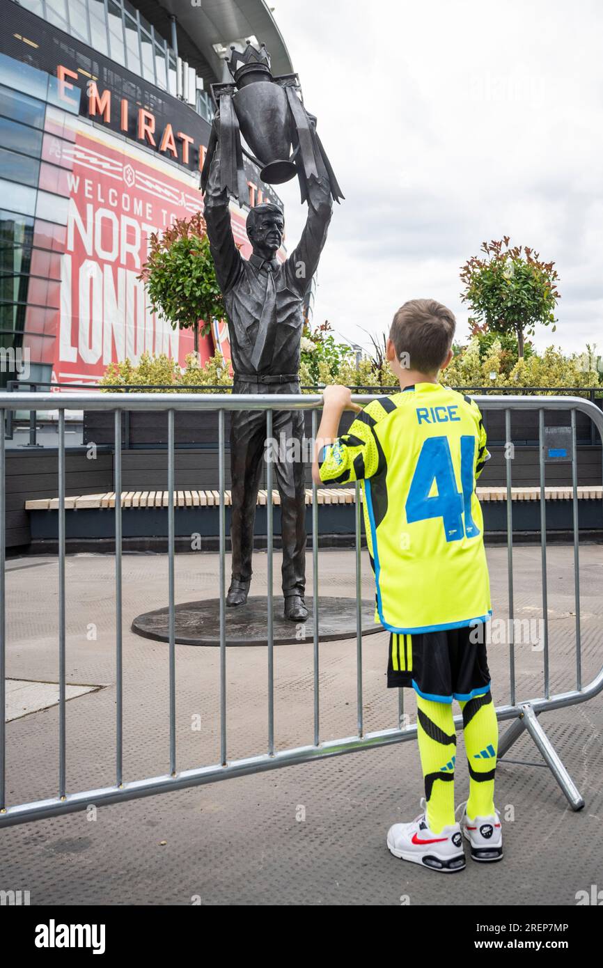 London, UK. 29 July 2023. A young fan views the statue of Arsenal ...