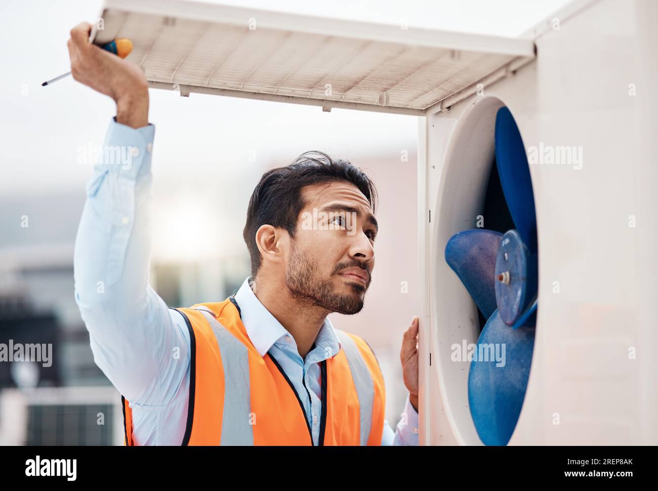 Engineer man, air conditioning and maintenance on roof, industry and ...