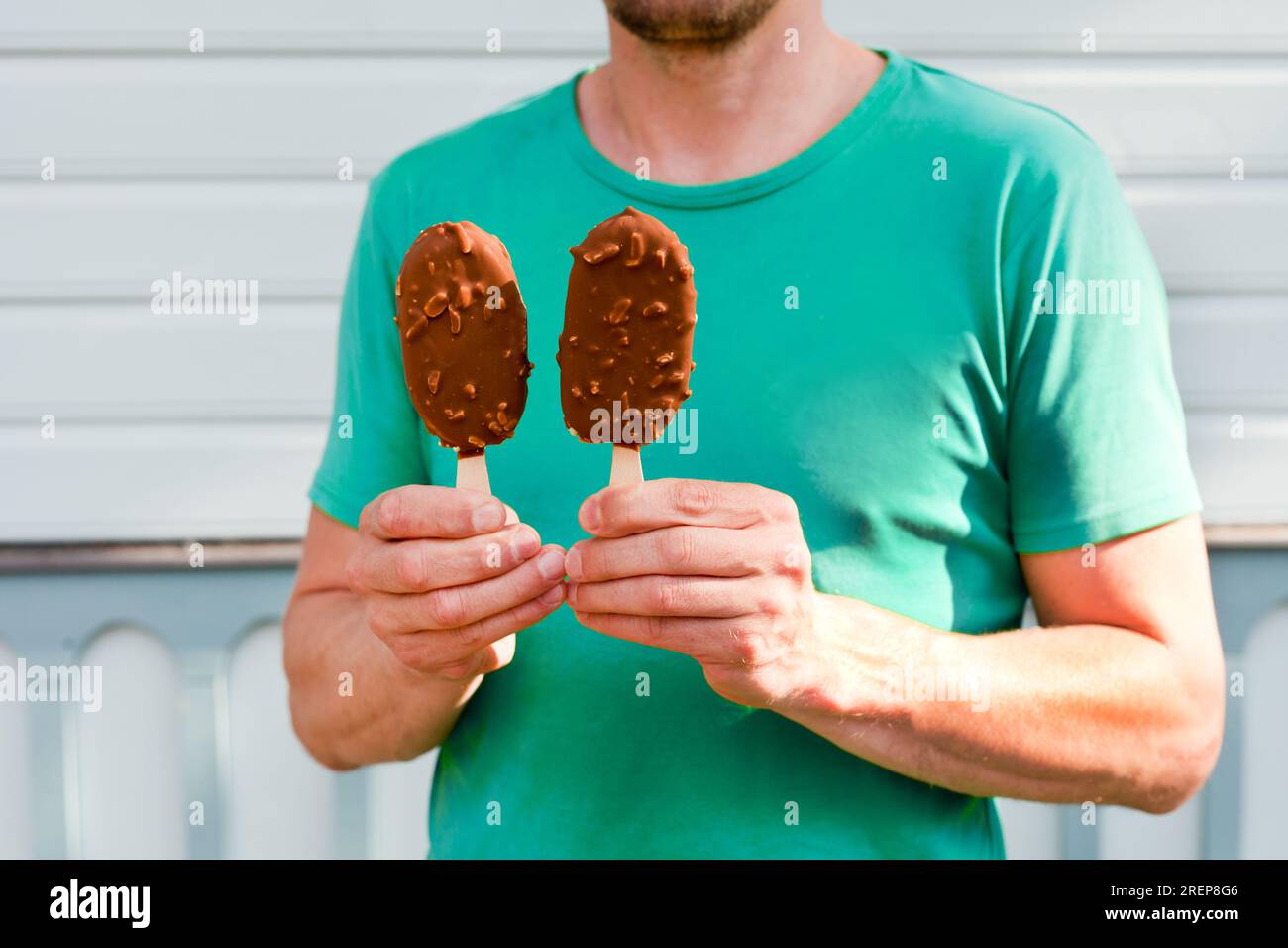 man hands holding two ice creams. guy holding ice cream on blue ...
