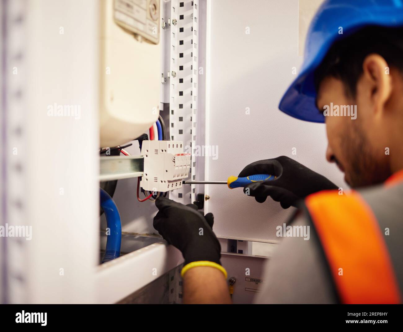 Electrician, screwdriver and repair with man in control room for tools ...