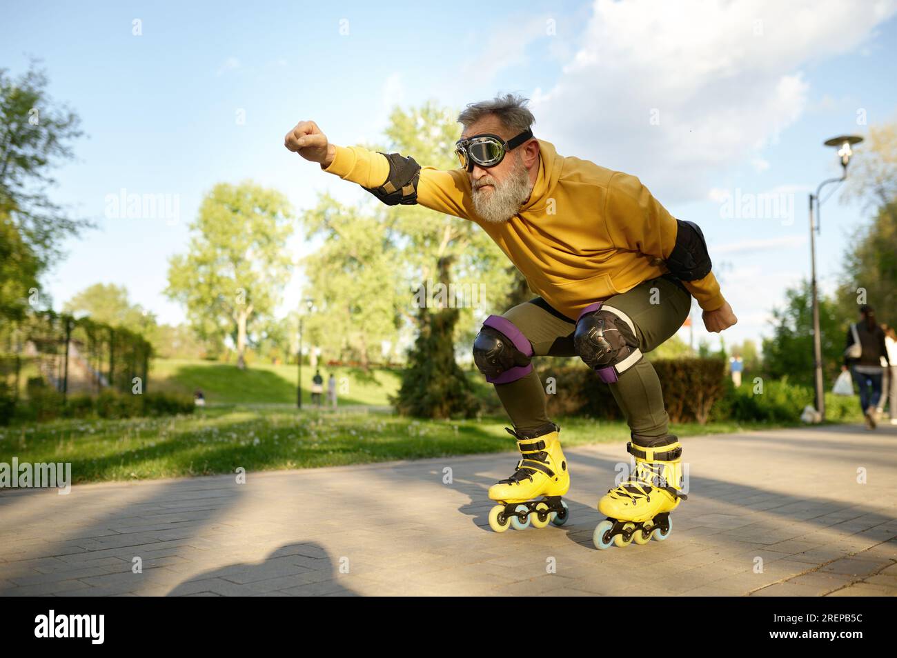 Funky mature man riding like aviator moving fast on roller skates Stock ...