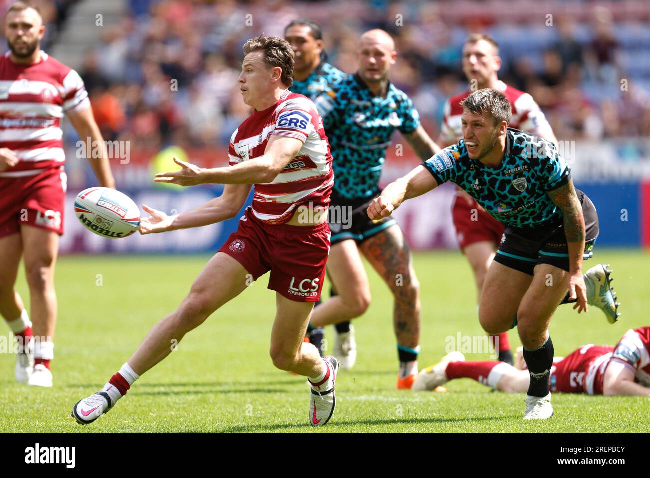 Wigan Warriors' Jai Field (2nd from left) passes to Bevan French who ...