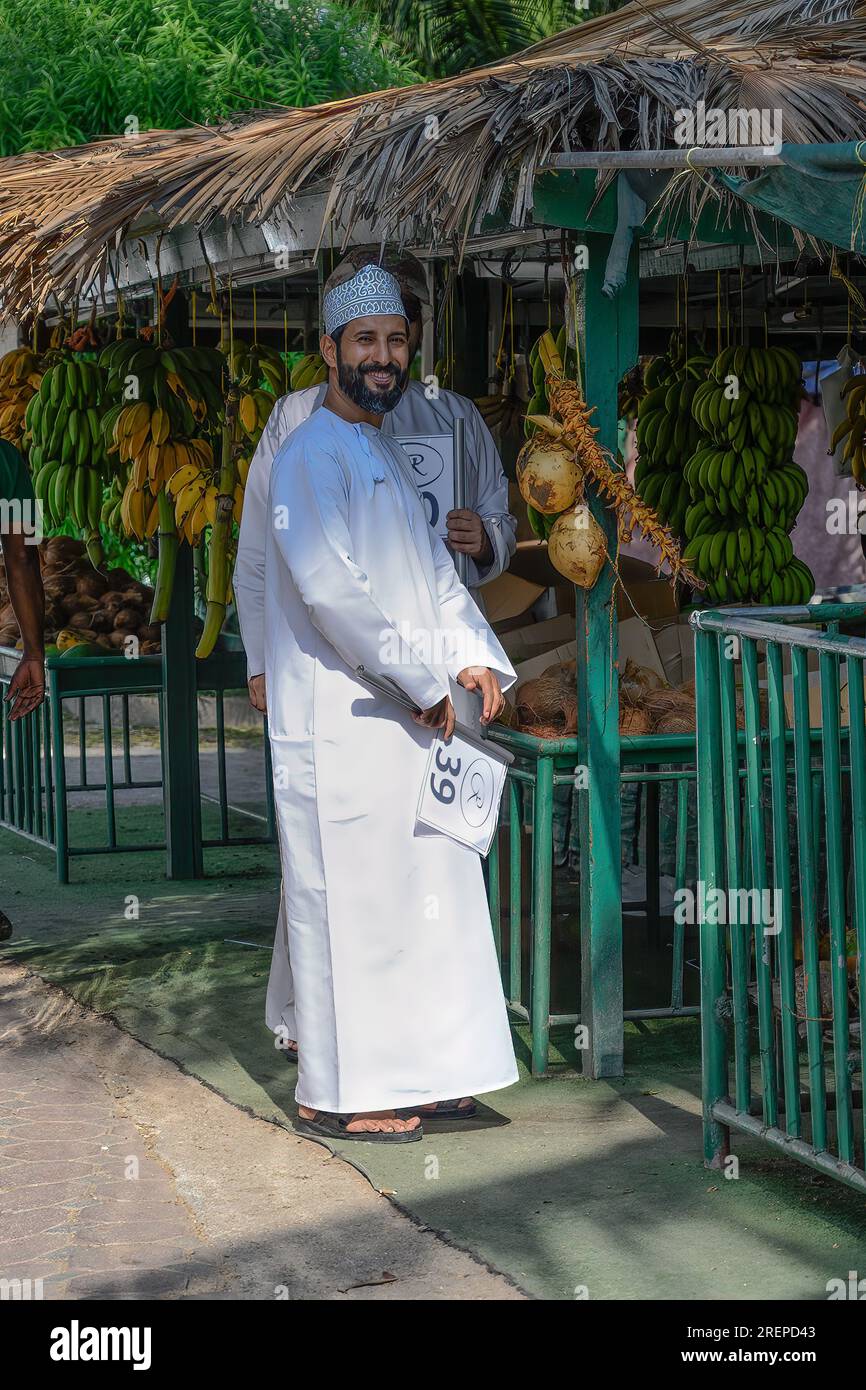 Salalah, Oman -- April 20, 2023. A smiling tour guide leads the way to ...