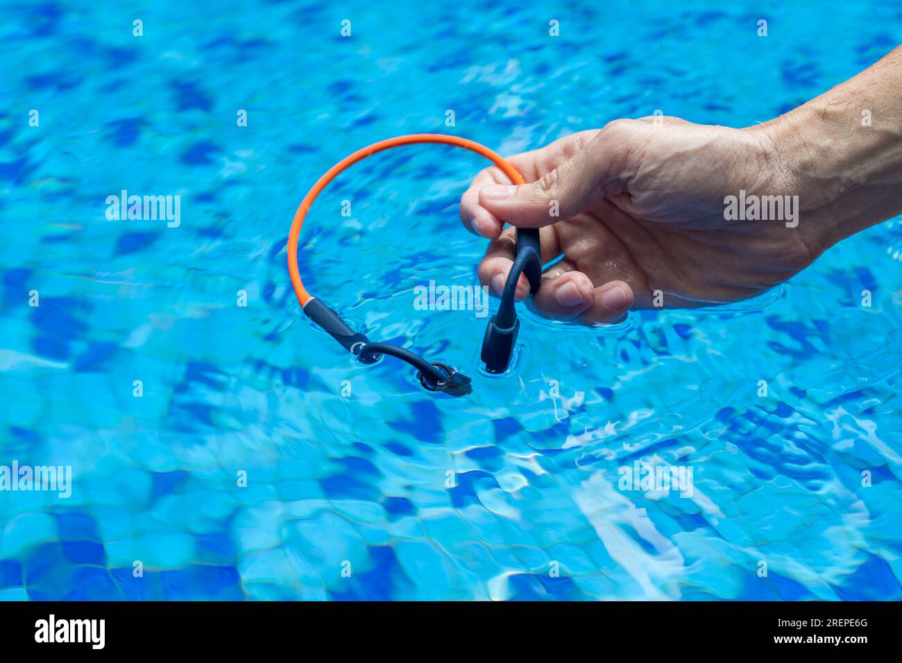 Waterproof audio device submerged in water. Headphones with bone ...